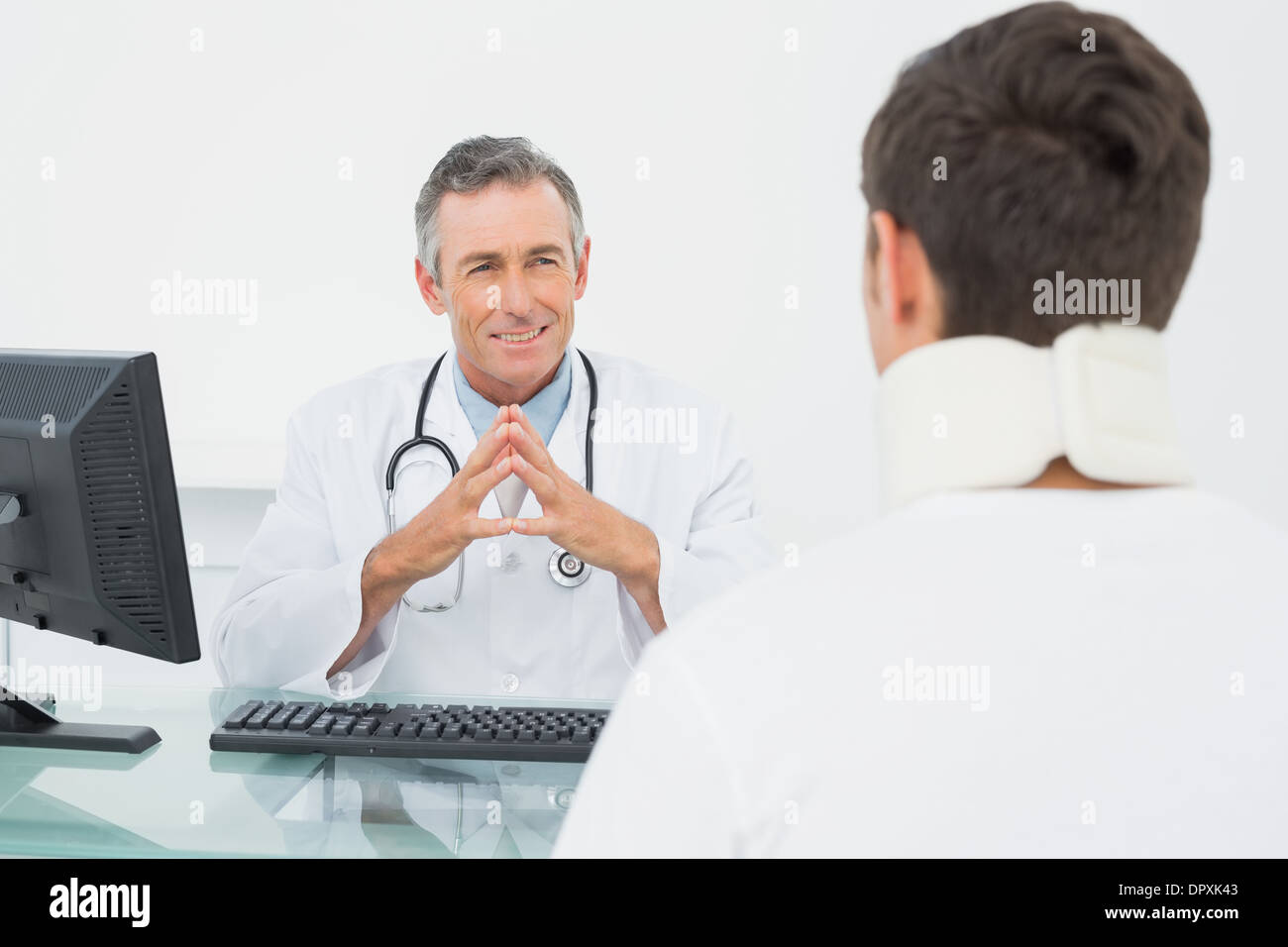 Doctor in conversation with patient at office Stock Photo - Alamy