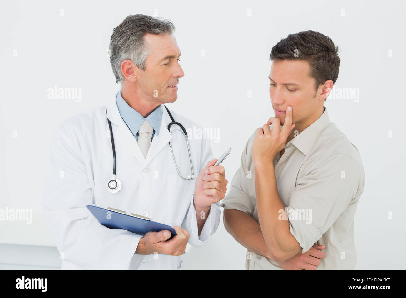 Doctor in conversation with patient in office Stock Photo - Alamy