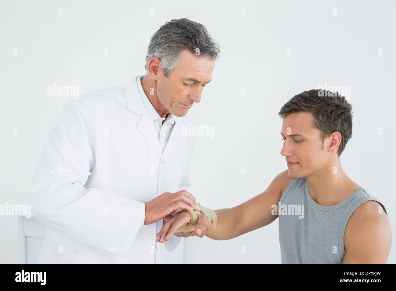 Doctor examining a patients hand Stock Photo - Alamy