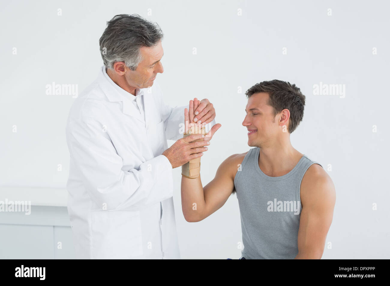 Doctor examining a patients hand Stock Photo - Alamy