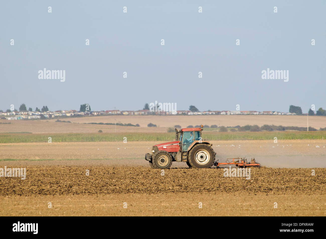 A tractor muck-spreading on agricultural land on the Isle of Sheppey ...