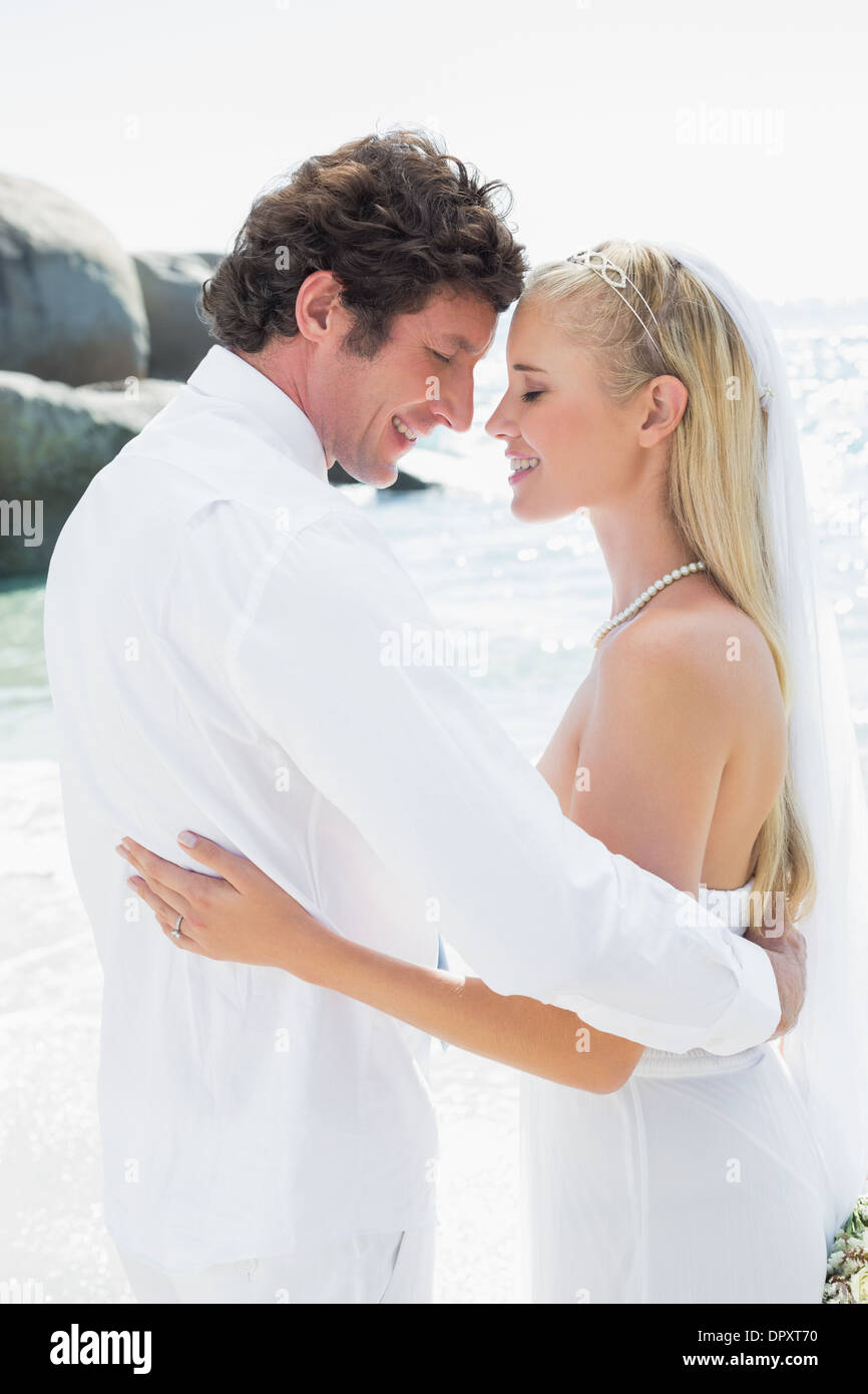 Smiling bride and groom hugging each other Stock Photo - Alamy