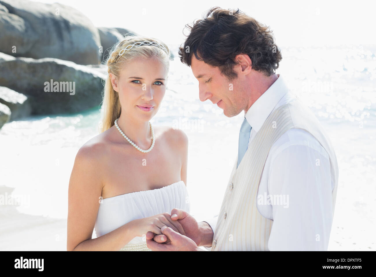 Pretty bride smiling at camera with new husband Stock Photo - Alamy