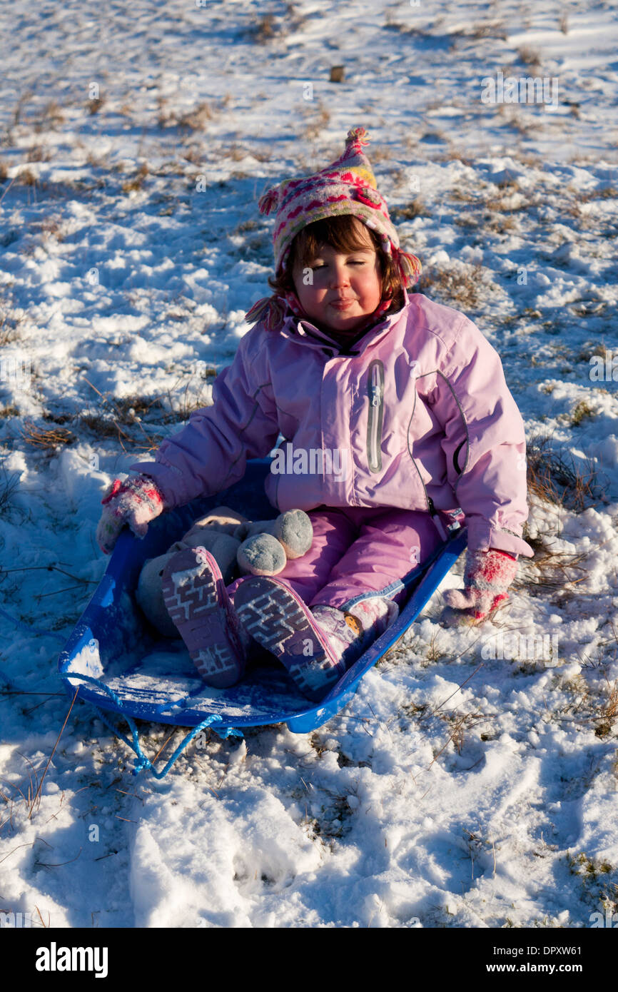 Young child on sled Stock Photo - Alamy