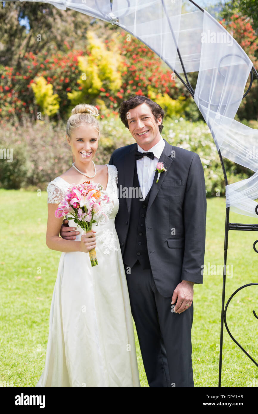 Attractive newlyweds smiling camera embracing hi-res stock photography ...