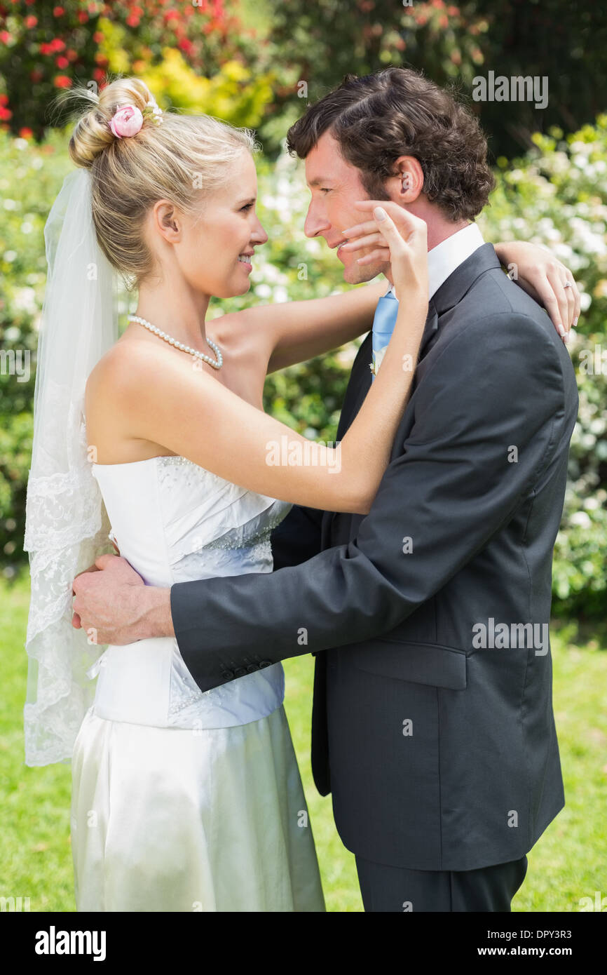 Happy wife touching her new husbands cheek Stock Photo - Alamy