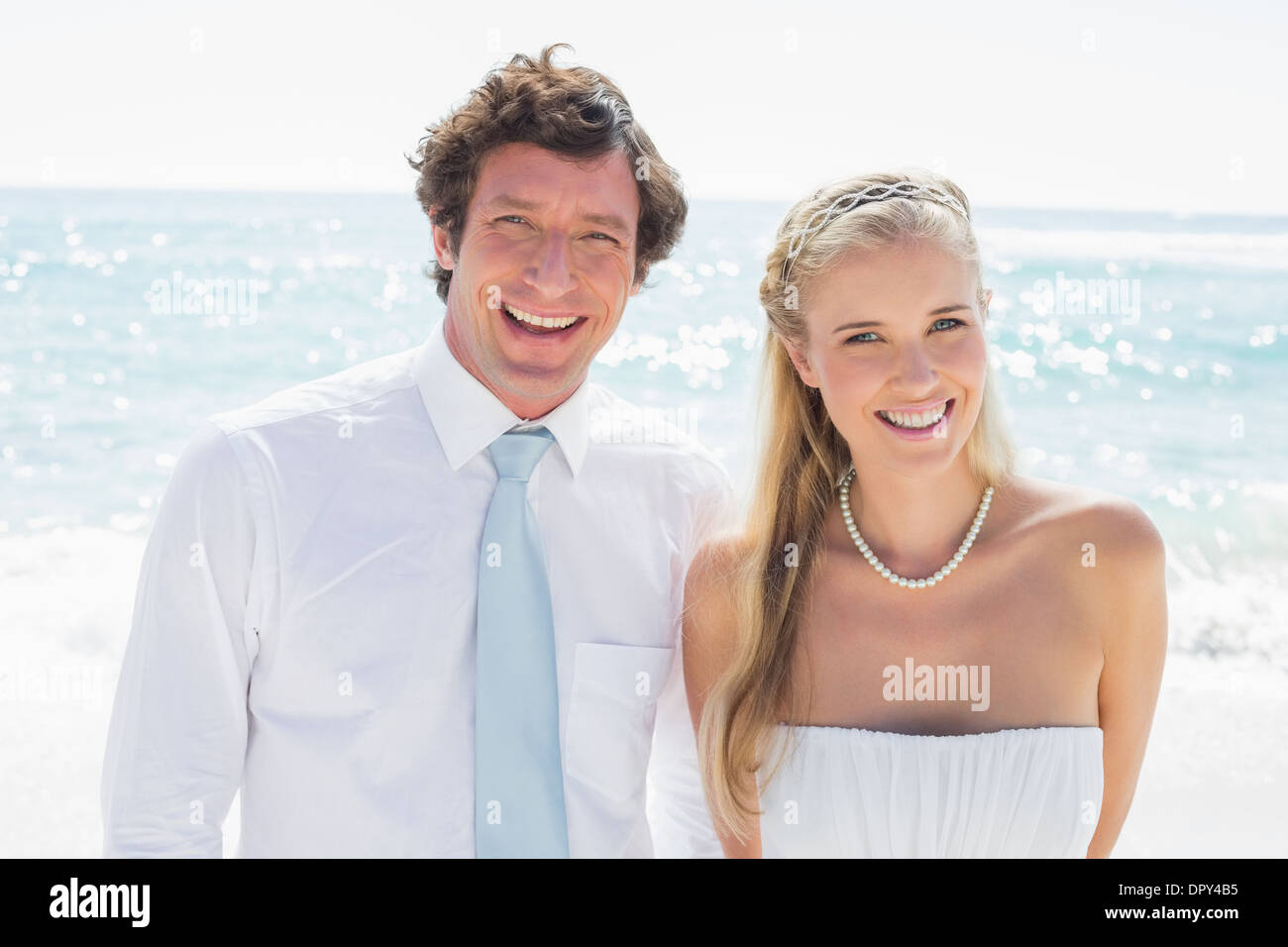 Romantic couple smiling at camera on their wedding day Stock Photo - Alamy