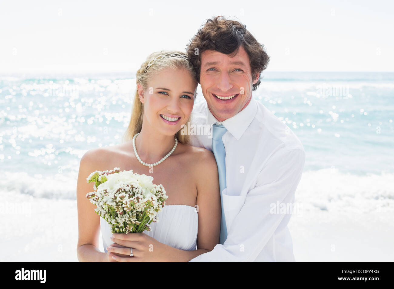 Romantic couple on their wedding day smiling at camera Stock Photo - Alamy