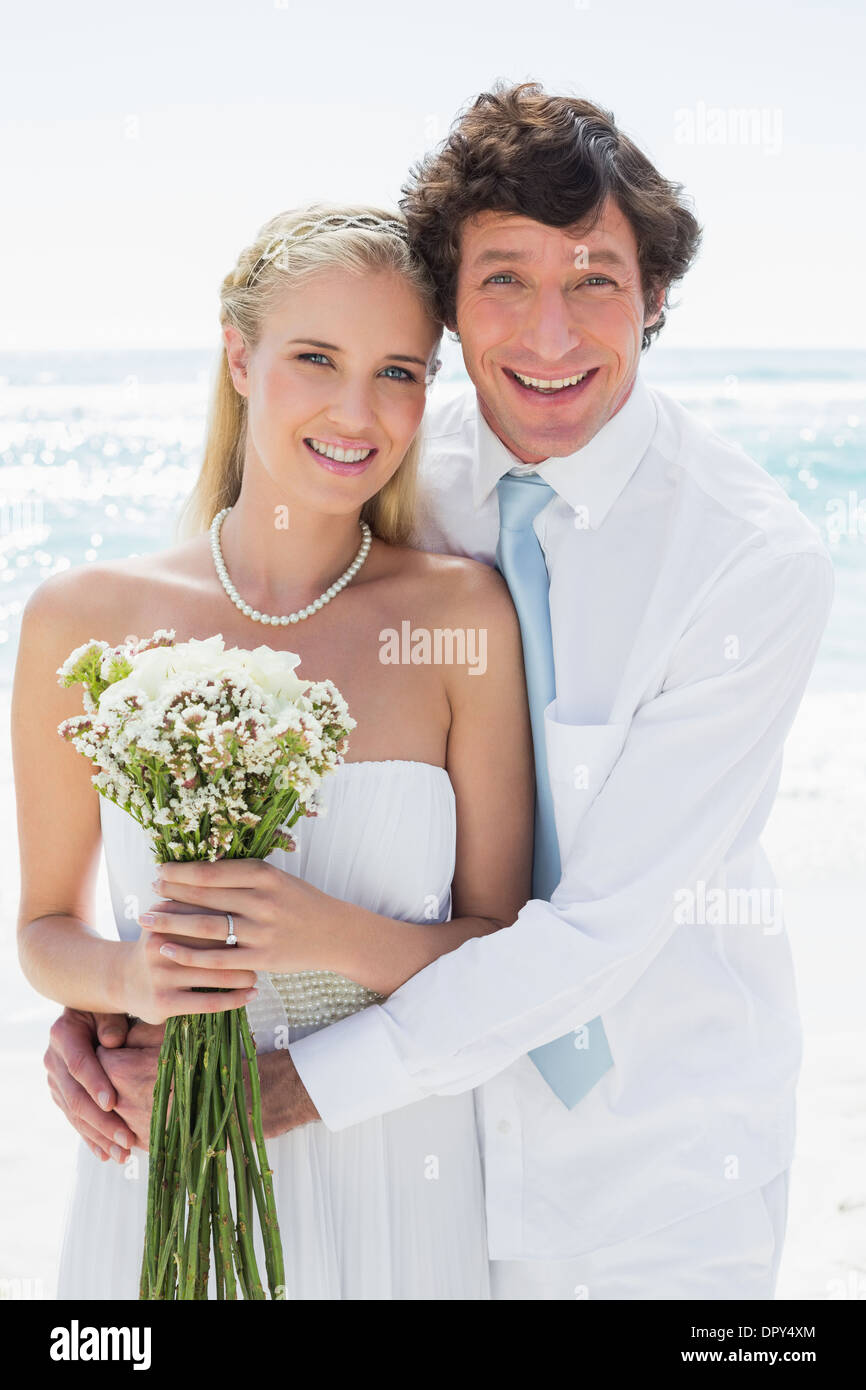 Happy couple on their wedding day smiling at camera Stock Photo - Alamy