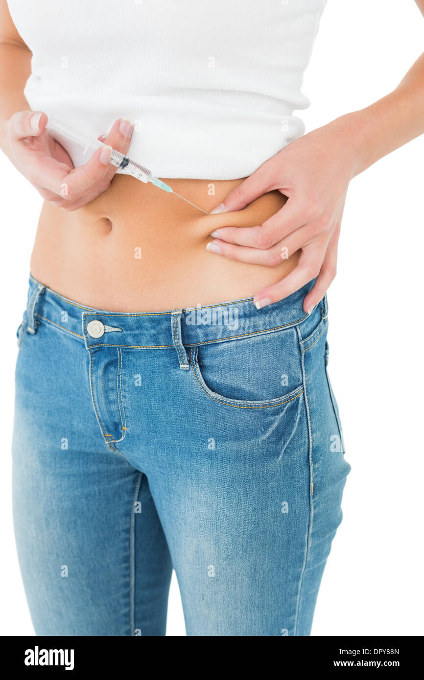 Close-up mid section of a woman injecting her belly Stock Photo - Alamy
