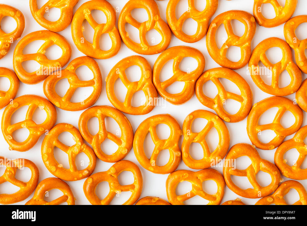 Salted fresh pretzels pattern as food background on white Stock Photo ...