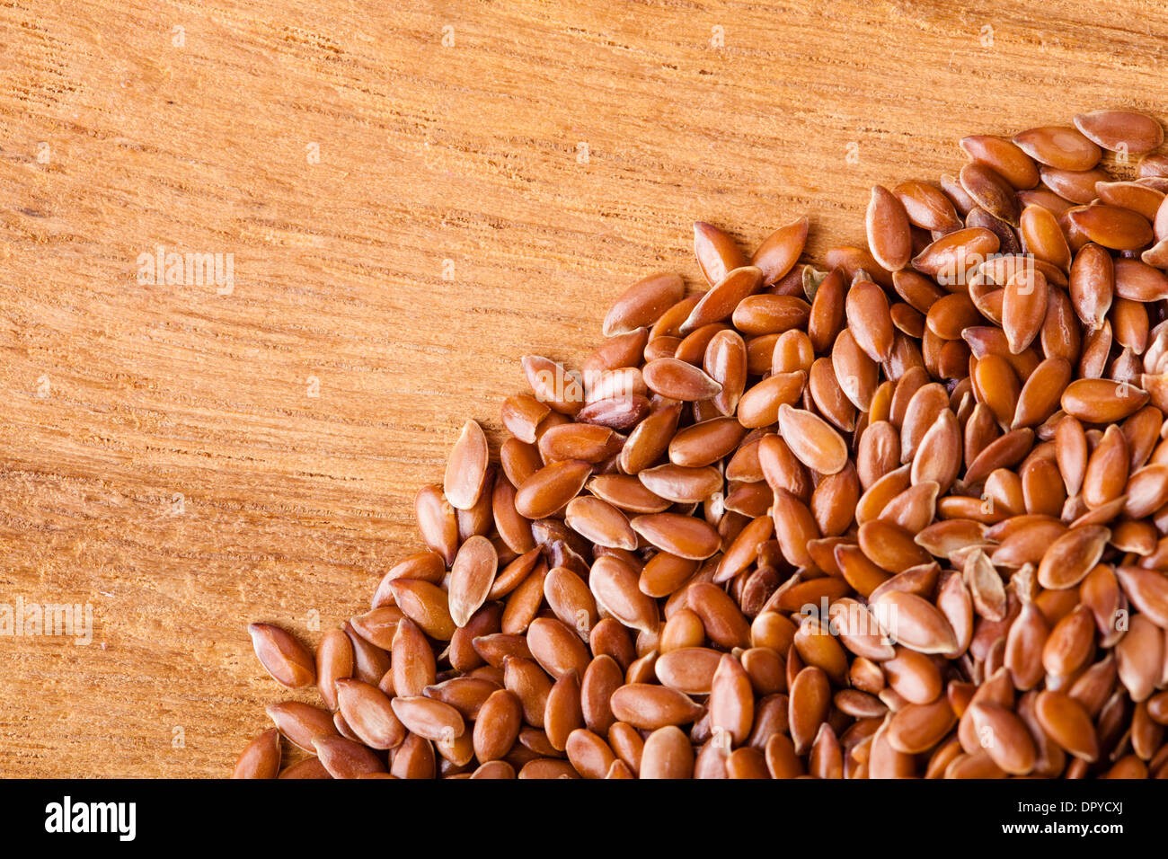 Healthy diet organic nutrition. Brown raw flax seeds linseed border frame on wooden table ...