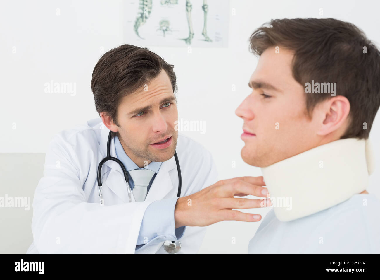 Doctor examining a patients sprained neck at office Stock Photo - Alamy