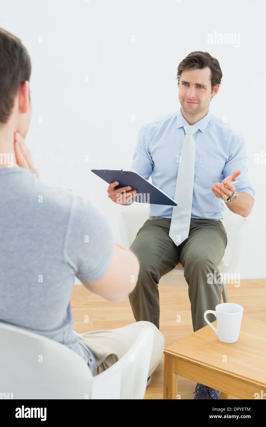 Well dressed male doctor in conversation with patient Stock Photo - Alamy