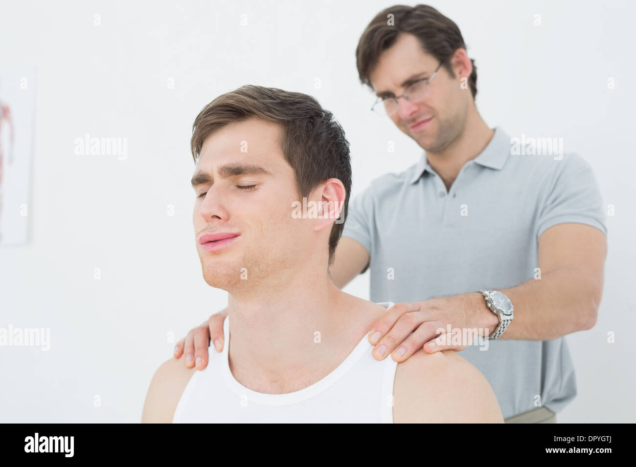Male physiotherapist massaging a mans shoulder Stock Photo - Alamy