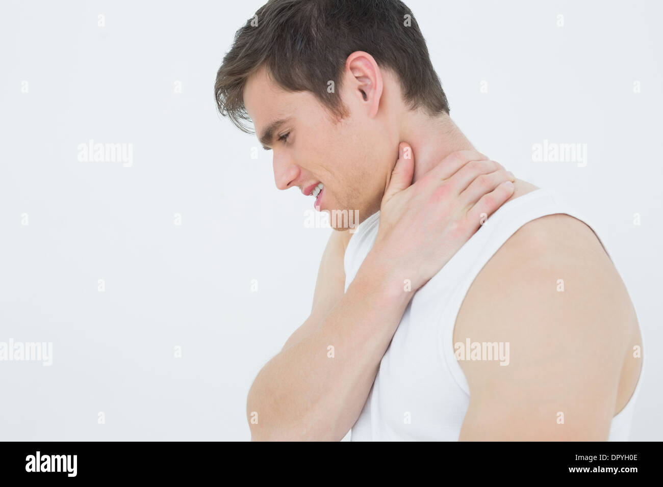 Close-up side view of a man suffering from neck pain Stock Photo - Alamy