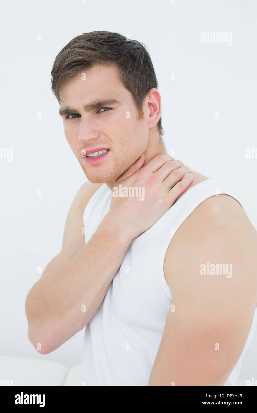 Side view portrait of a young man suffering from neck pain Stock Photo ...