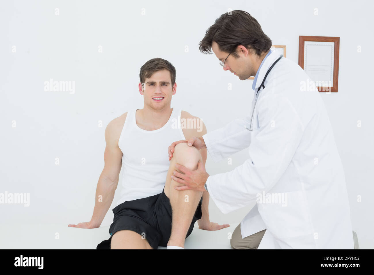 Happy young man patient touching hi-res stock photography and images ...