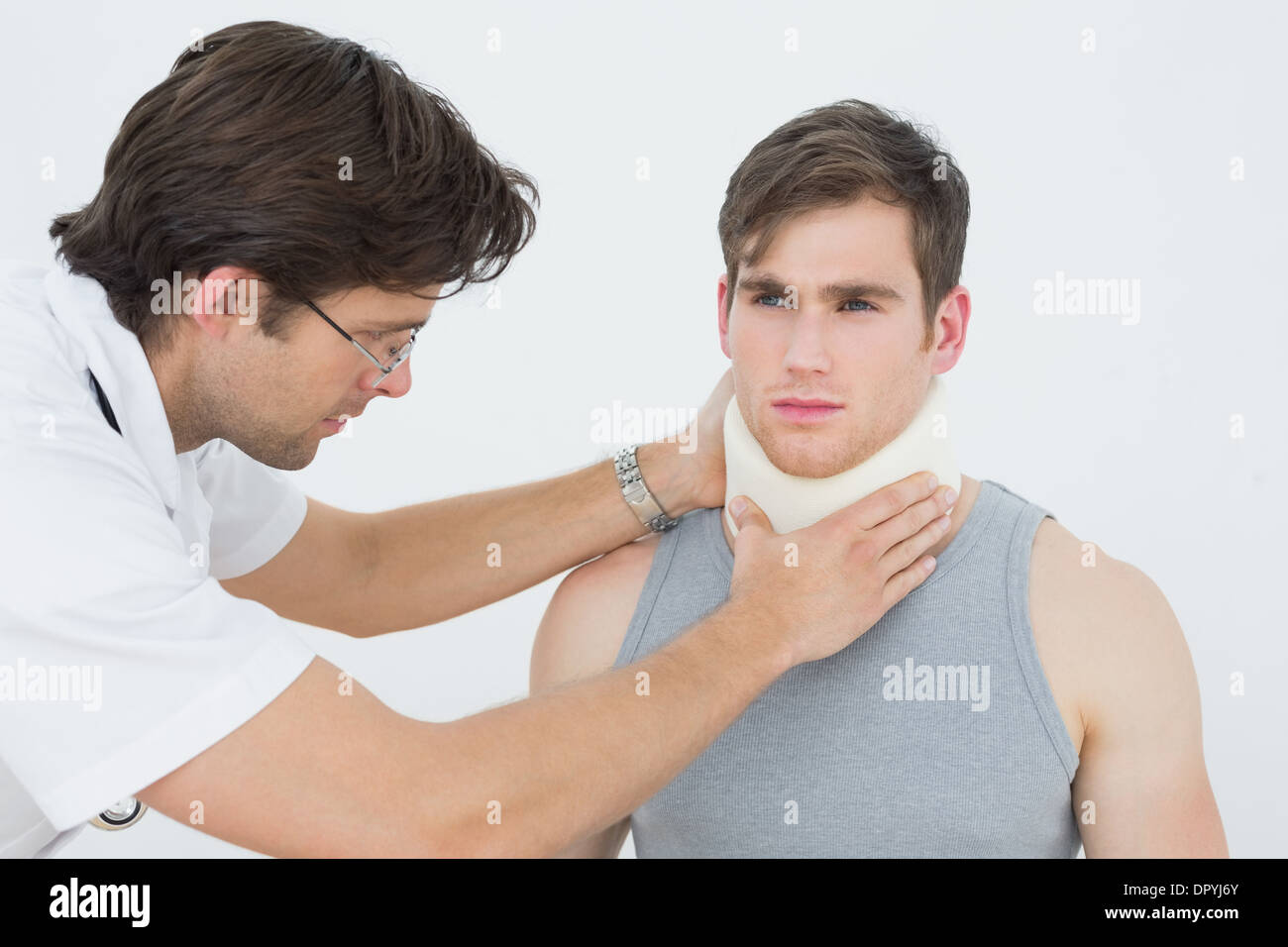 Male doctor examining a patients neck Stock Photo - Alamy