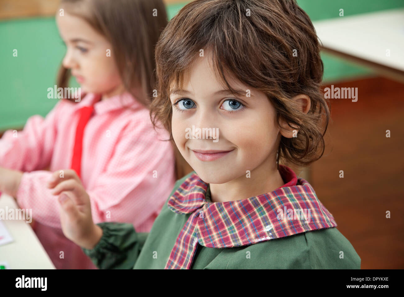 Little Boy Smiling With Classmate In Background Stock Photo - Alamy