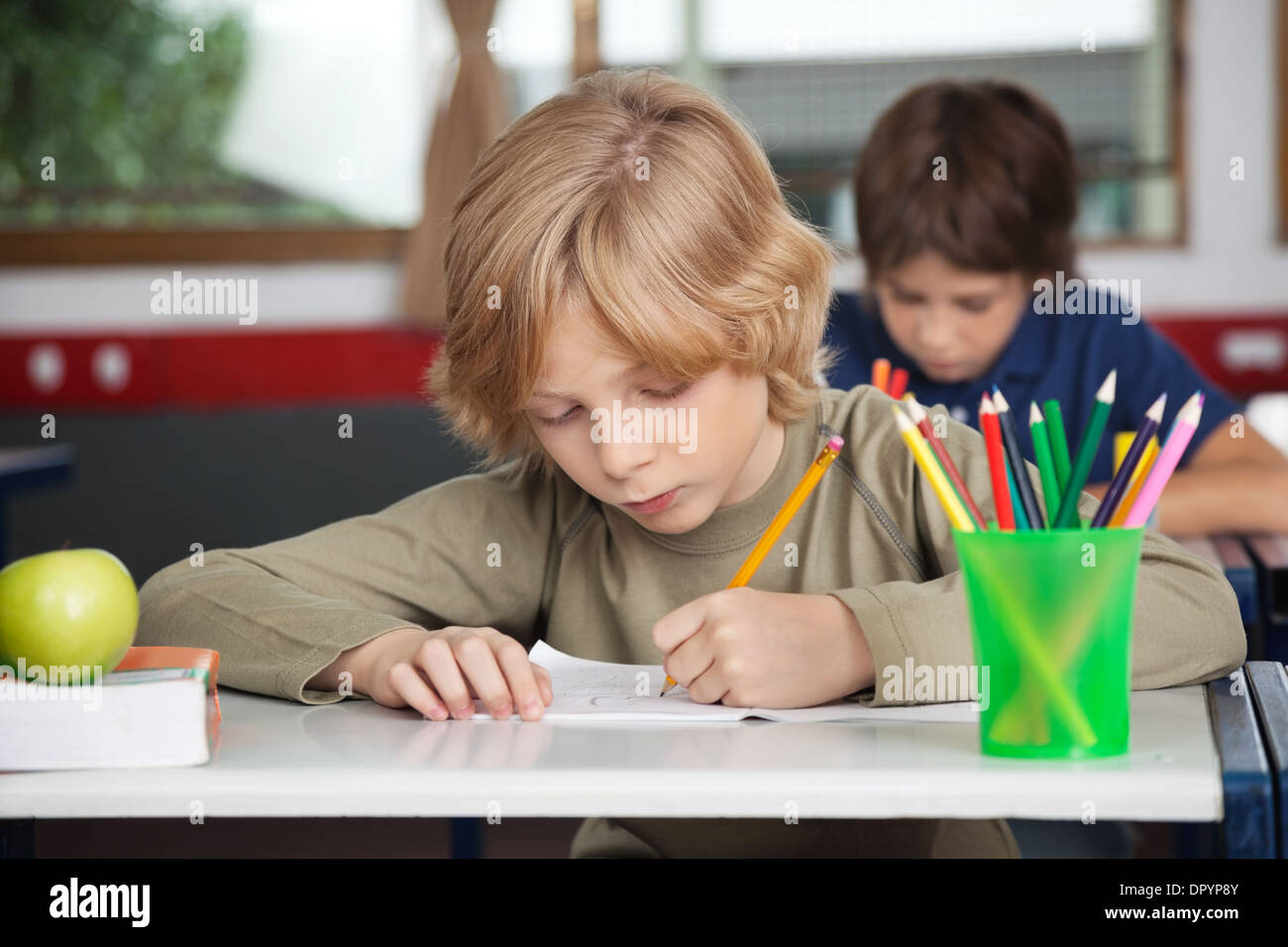 Cute boy writing in book hi-res stock photography and images - Alamy