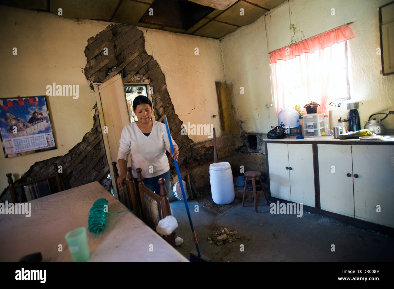 Arelis de Leon, 37, cleans that was damaged after a 7.4 earthquake ...