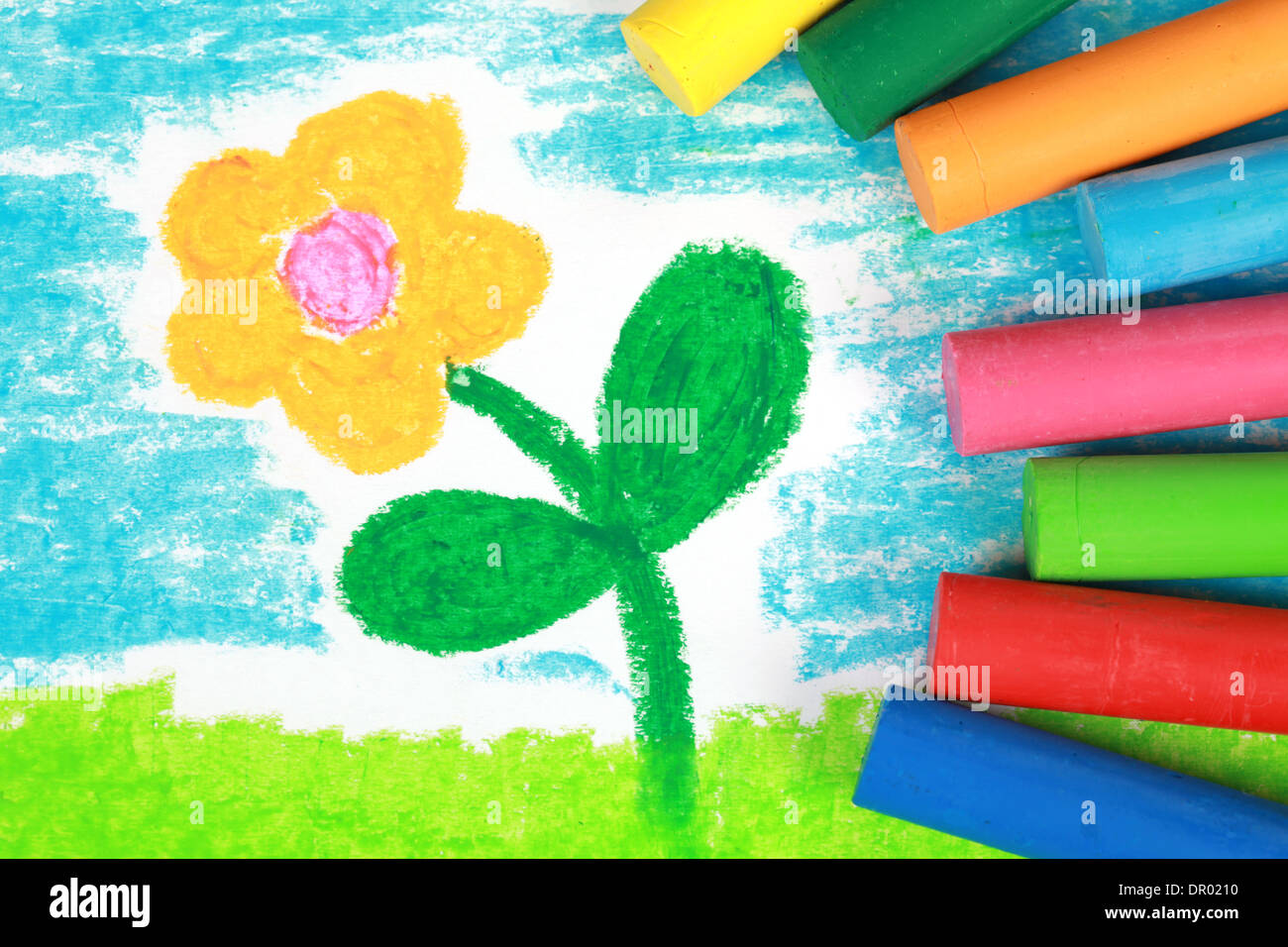 Kiddie style crayon drawing of a flower on a meadow Stock Photo - Alamy
