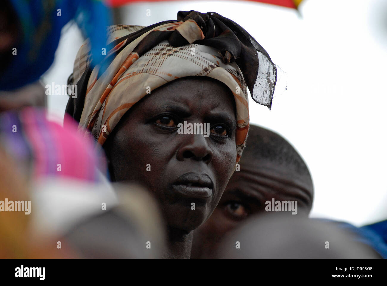 A displaced Congolese woman waits for food distribution carried out by ...