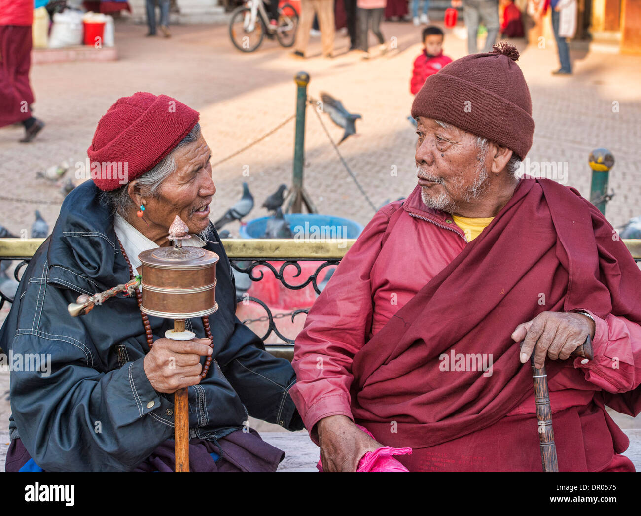 Tibetan pilgrims and prayer wheel at the Boudhanath Stupa in Kathmandu ...