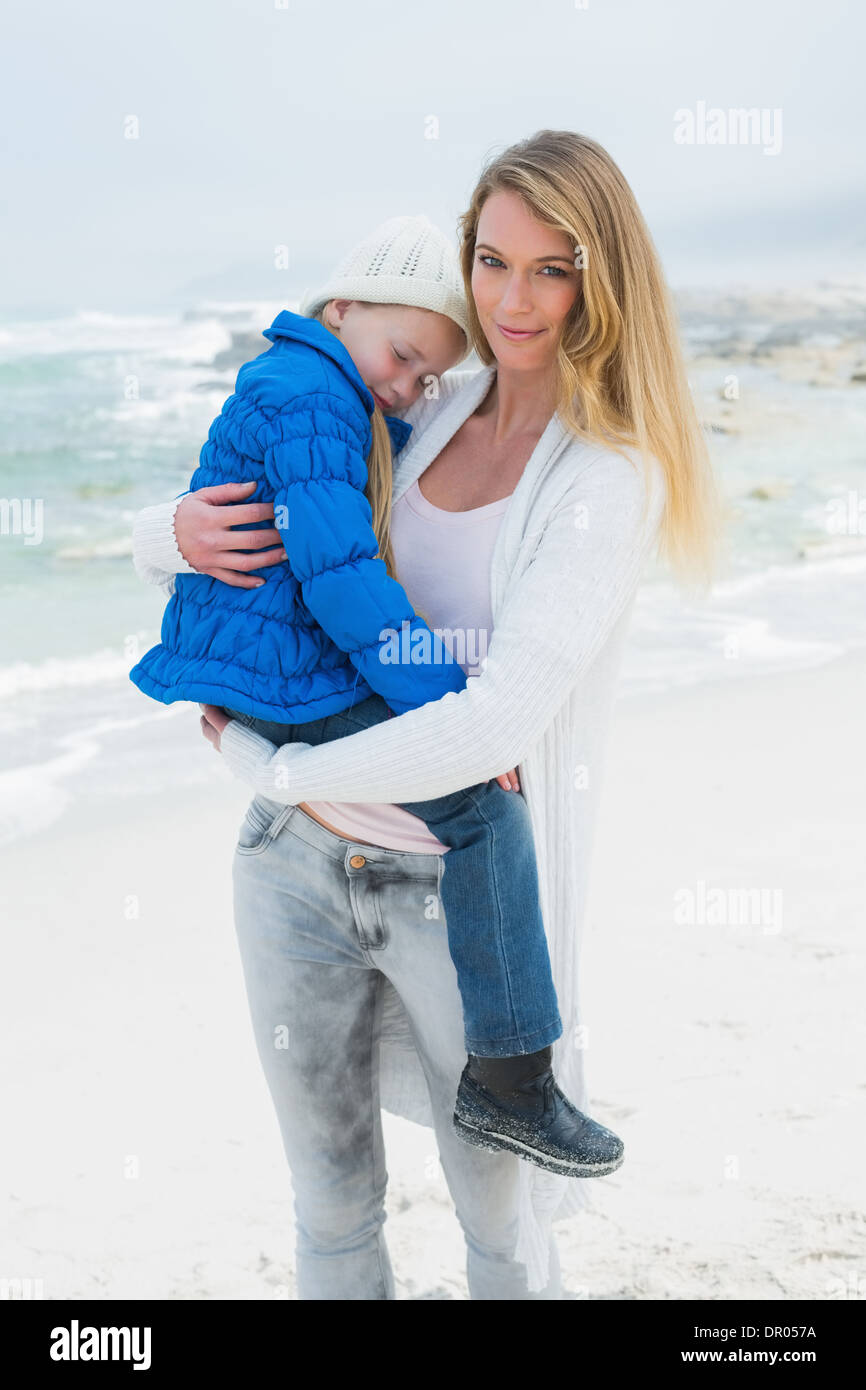 Woman carrying sleeping child hi-res stock photography and images - Alamy