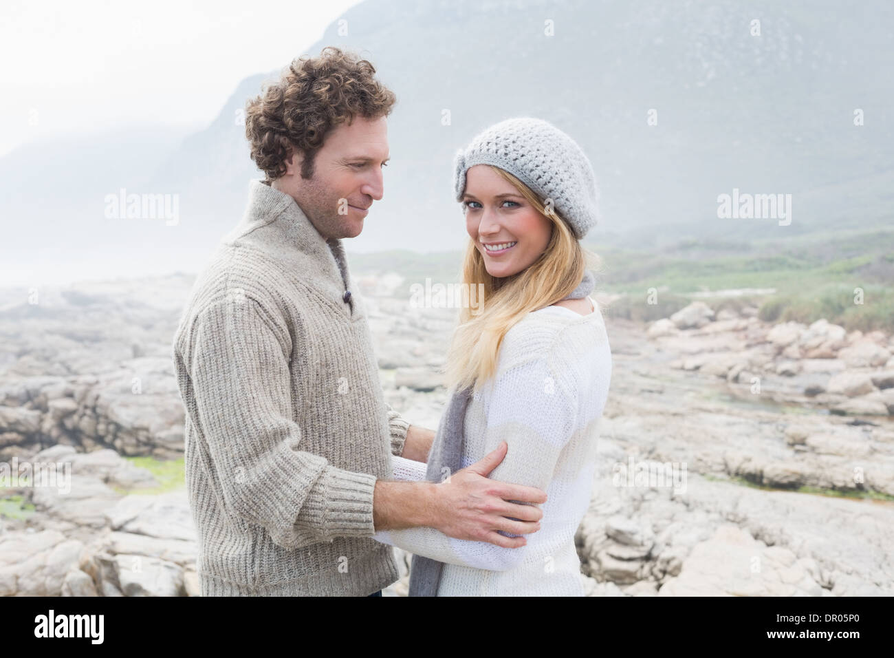 Couple standing together on a rocky landscape Stock Photo - Alamy