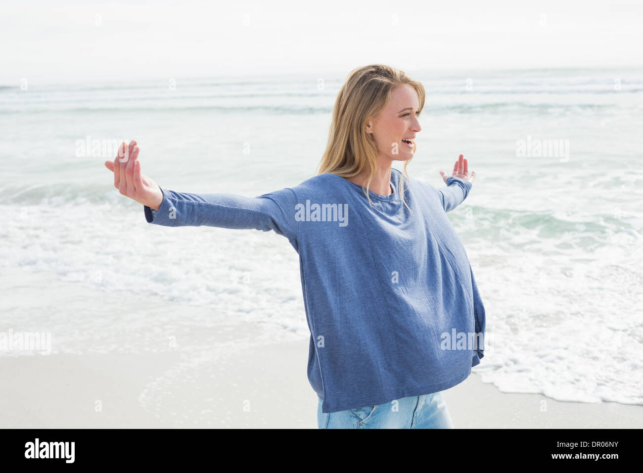 Woman standing with arms outstretched at beach Stock Photo - Alamy