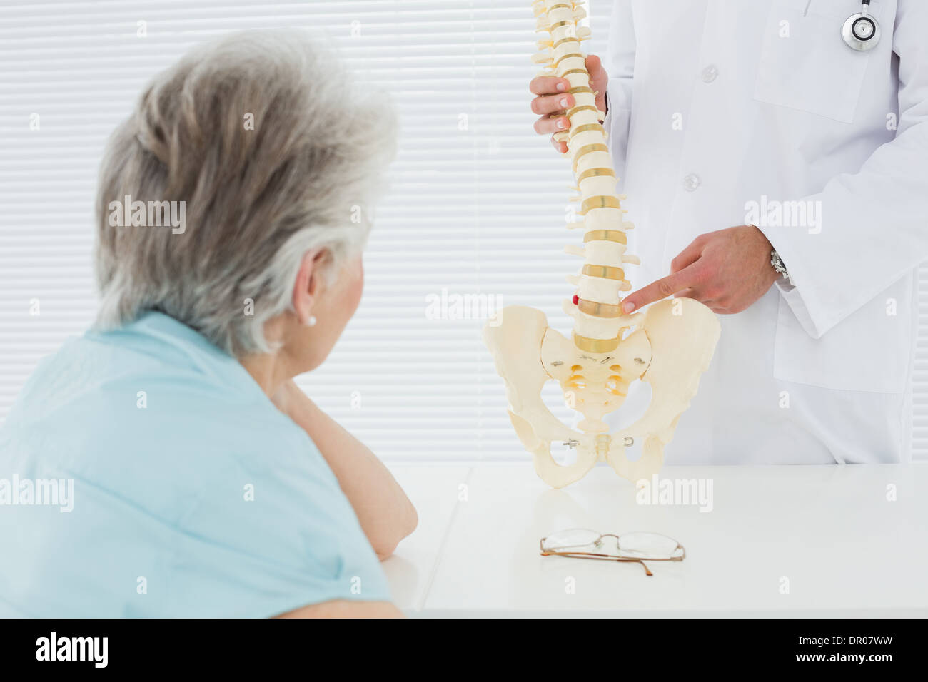 Male doctor explaining the spine to a senior patient Stock Photo - Alamy