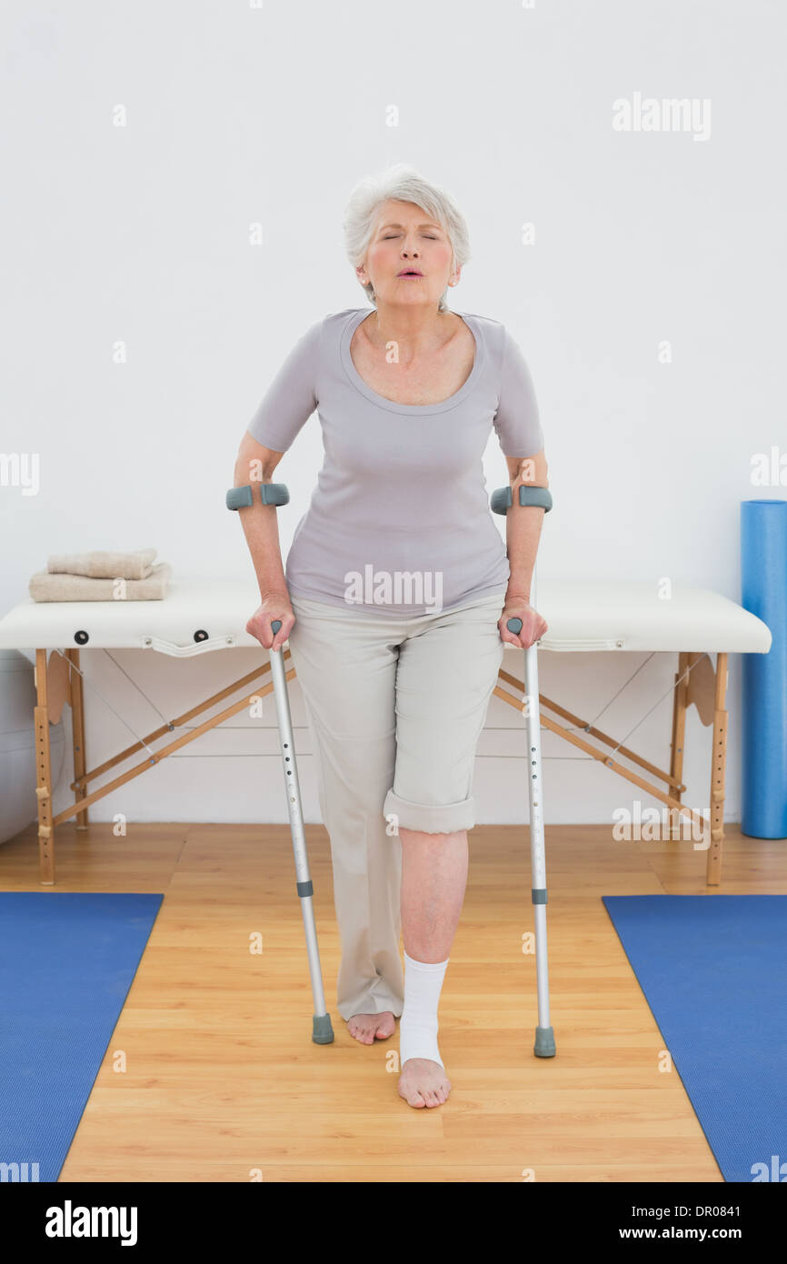 Old lady walking crutches hi-res stock photography and images - Alamy