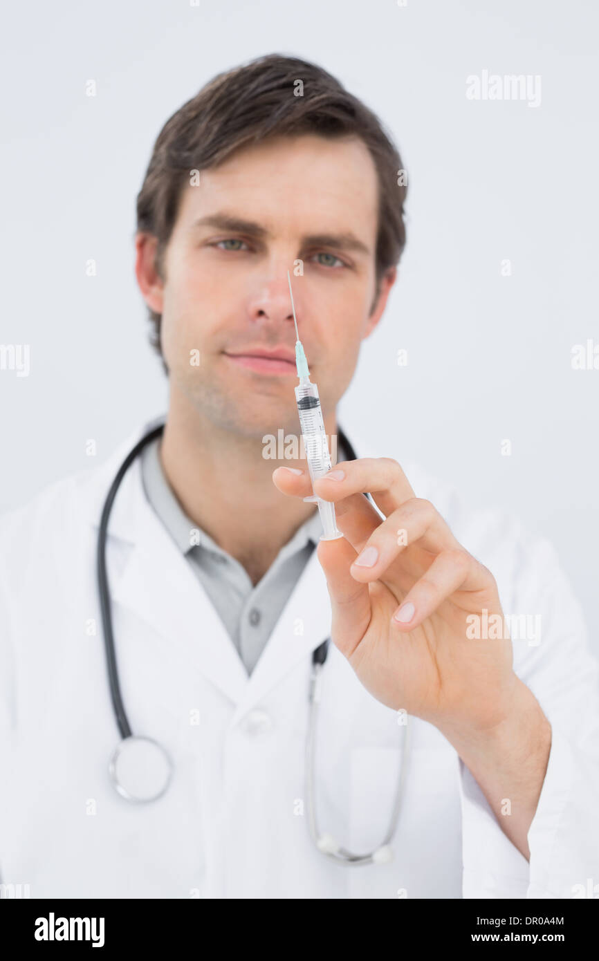 Handsome male doctor holding injection hi-res stock photography and ...