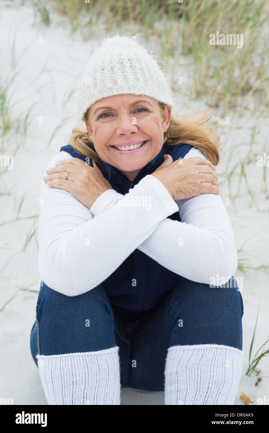 Happy senior woman feeling cold at beach Stock Photo - Alamy