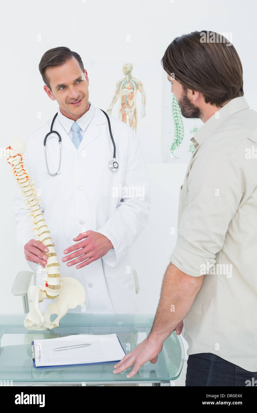 Male doctor explaining the spine to a patient Stock Photo - Alamy