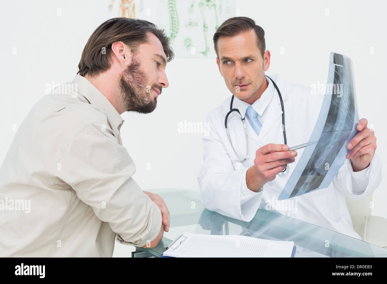 Male doctor explaining spine x-ray to patient Stock Photo - Alamy