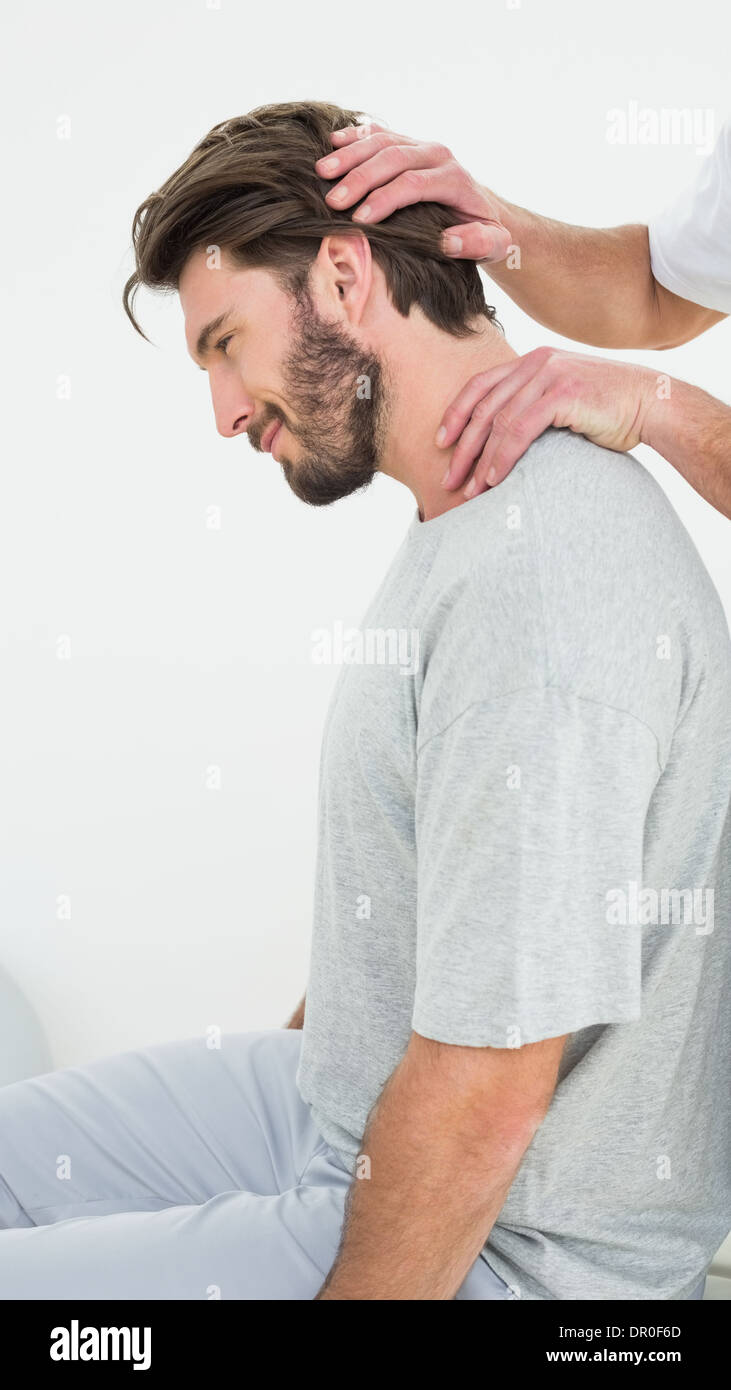 Side view of a man getting the neck adjustment done Stock Photo - Alamy