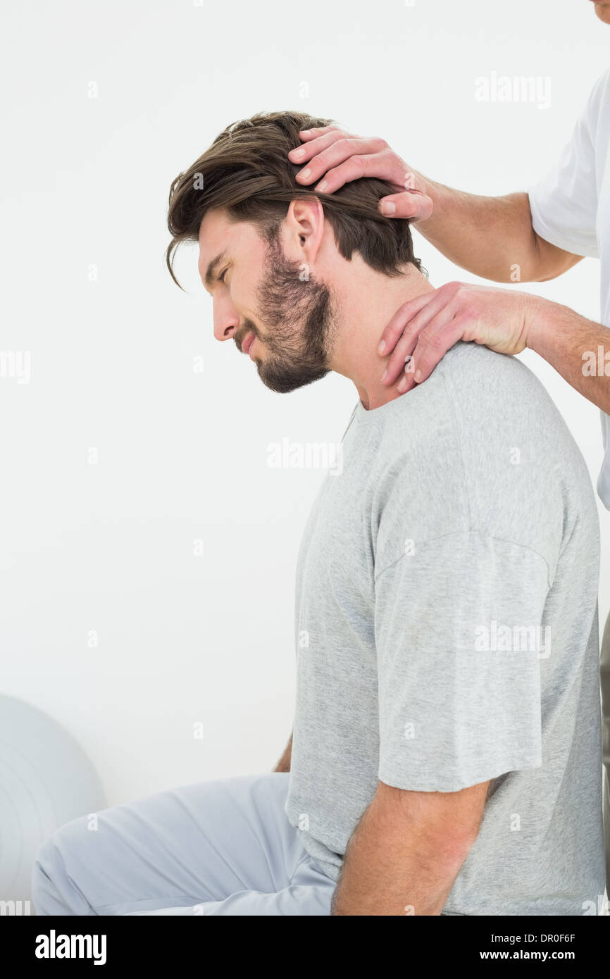 Side view of a man getting the neck adjustment done Stock Photo - Alamy