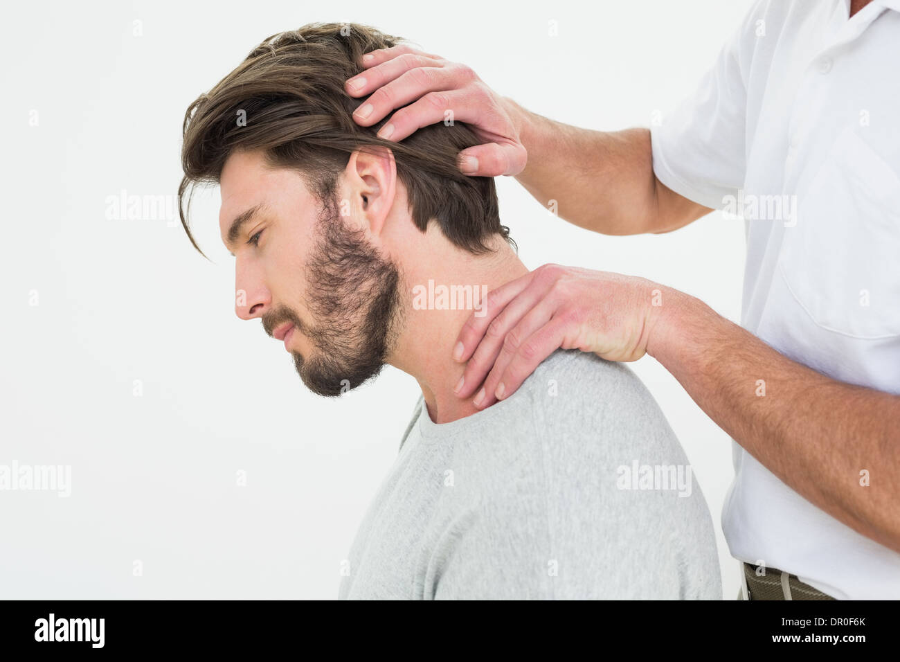 Side view of a man getting the neck adjustment done Stock Photo - Alamy