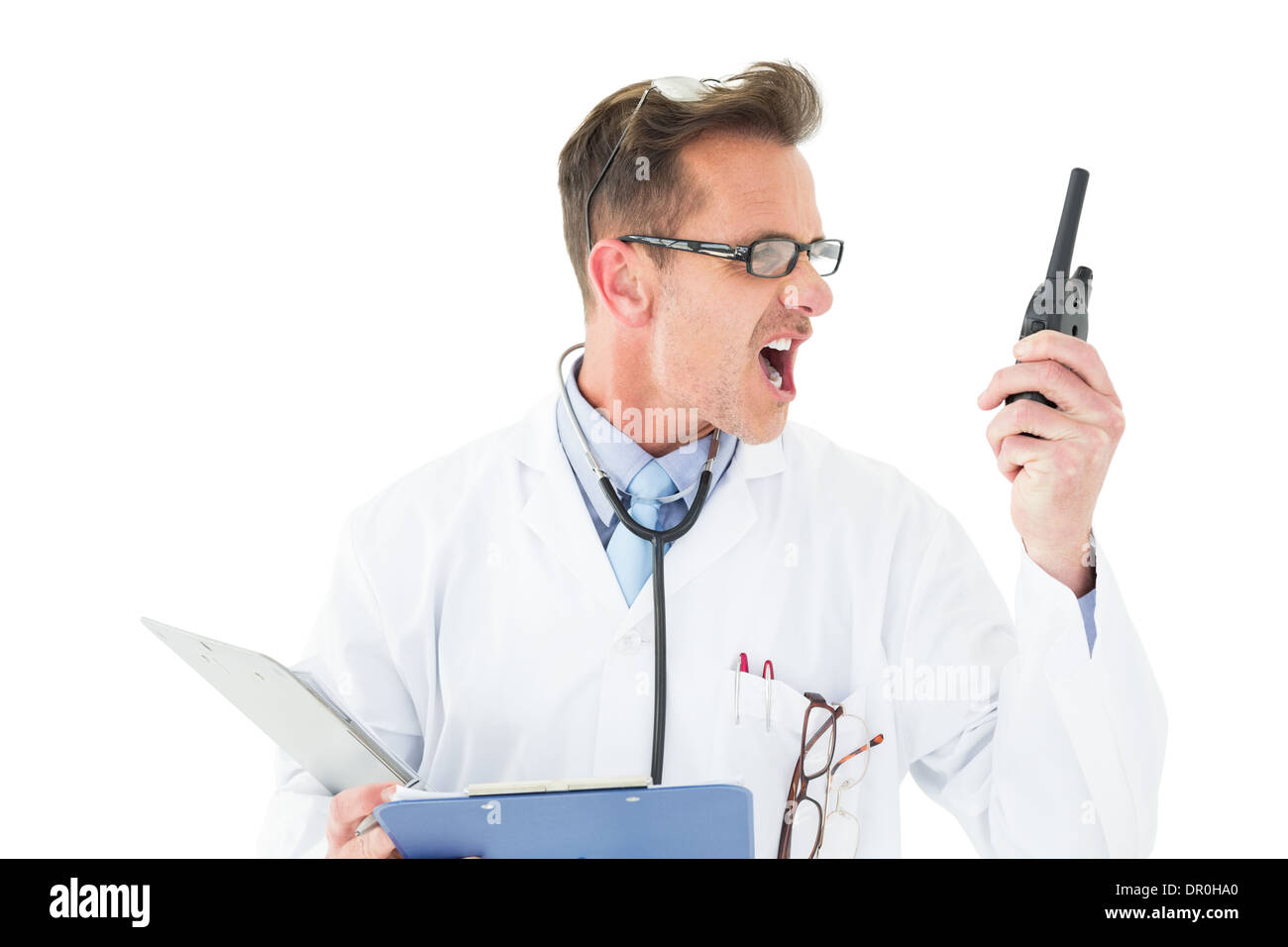 Annoyed doctor with clipboard shouting into a wireless radio Stock ...