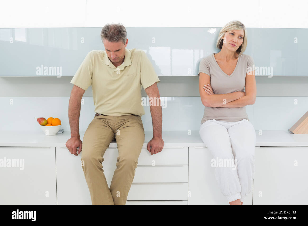 Angry couple after a fight in kitchen Stock Photo - Alamy