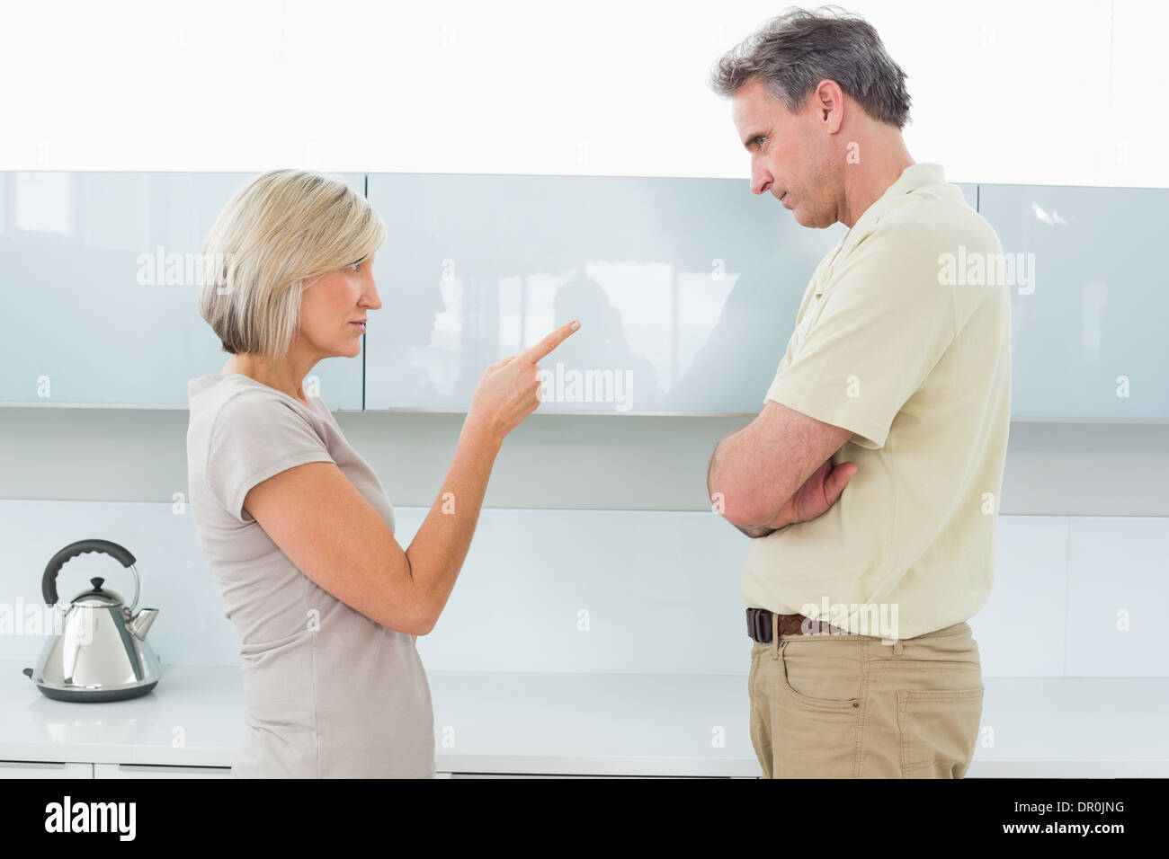 Angry couple arguing in kitchen Stock Photo - Alamy