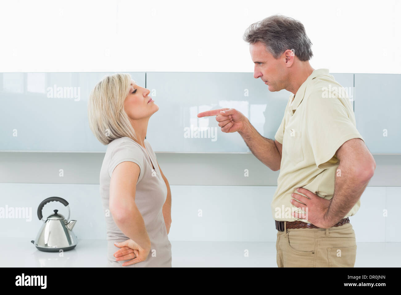 Angry couple arguing in kitchen Stock Photo - Alamy