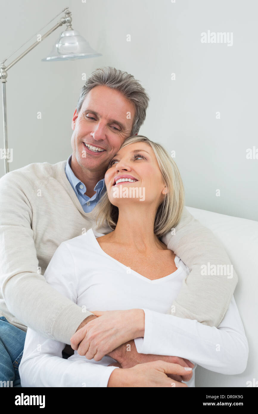 Happy relaxed couple embracing at home Stock Photo - Alamy