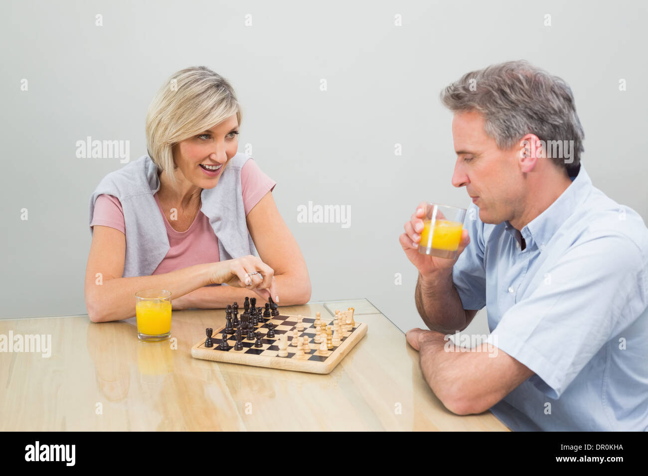 Concentrated couple playing chess Stock Photo - Alamy
