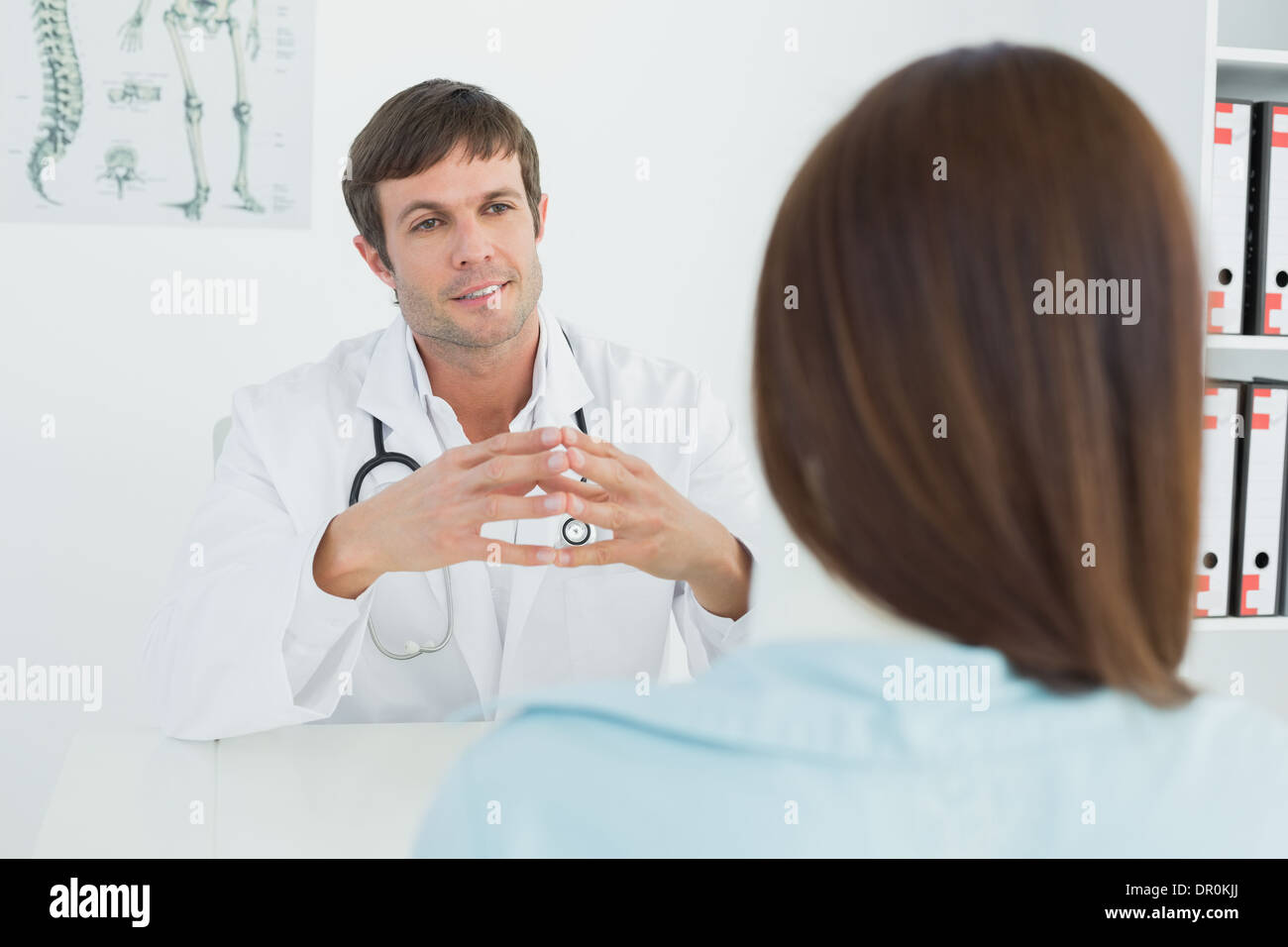 Doctor listening to patient with concentration in medical office Stock ...
