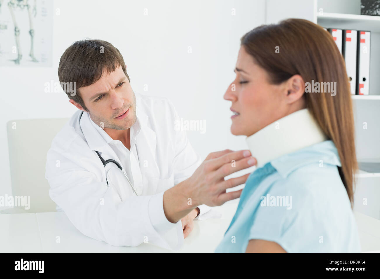 Doctor examining a patient's neck in medical office Stock Photo - Alamy