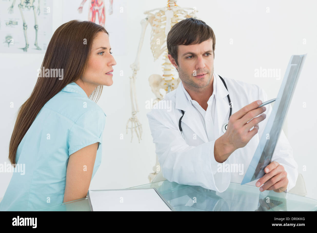Doctor explaining x-ray to female patient in the medical office Stock ...